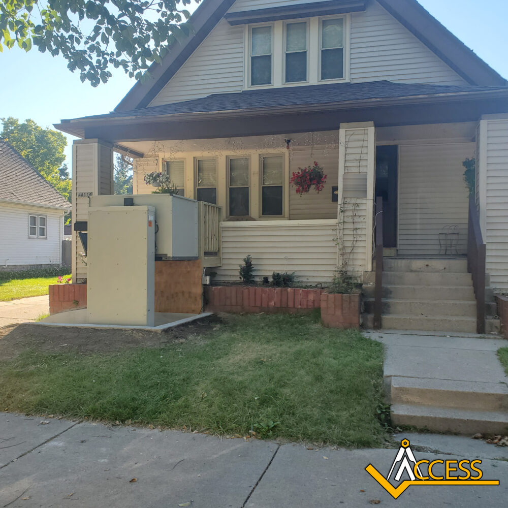 A house with a ramp and platform lift for wheelchair access beside ...