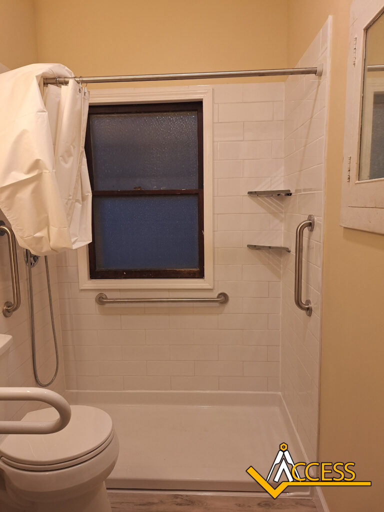Accessible bathroom with a walk-in shower, grab bars, a handheld ...