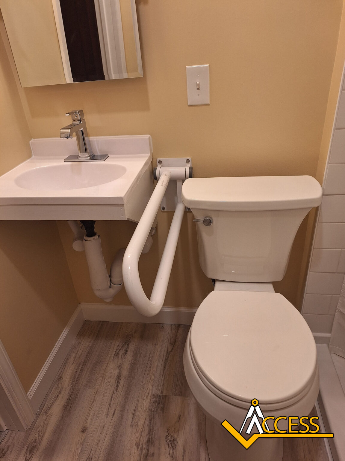 Accessible bathroom with a white toilet, a sink with a single-lever ...